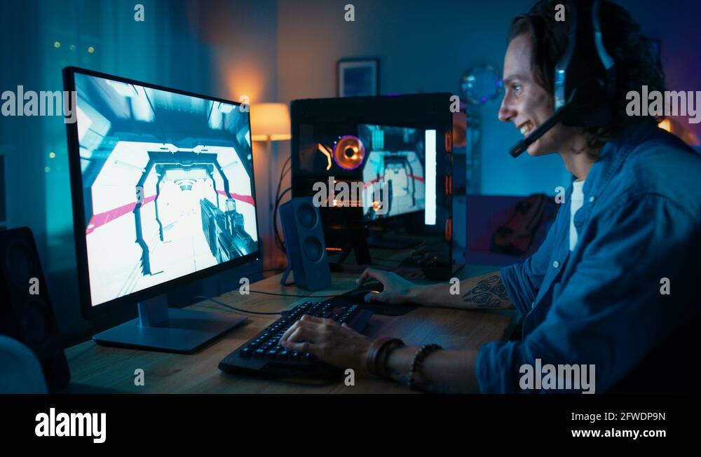 Excited Gamer Playing First-Person Shooter Online Video Game on His PC ...