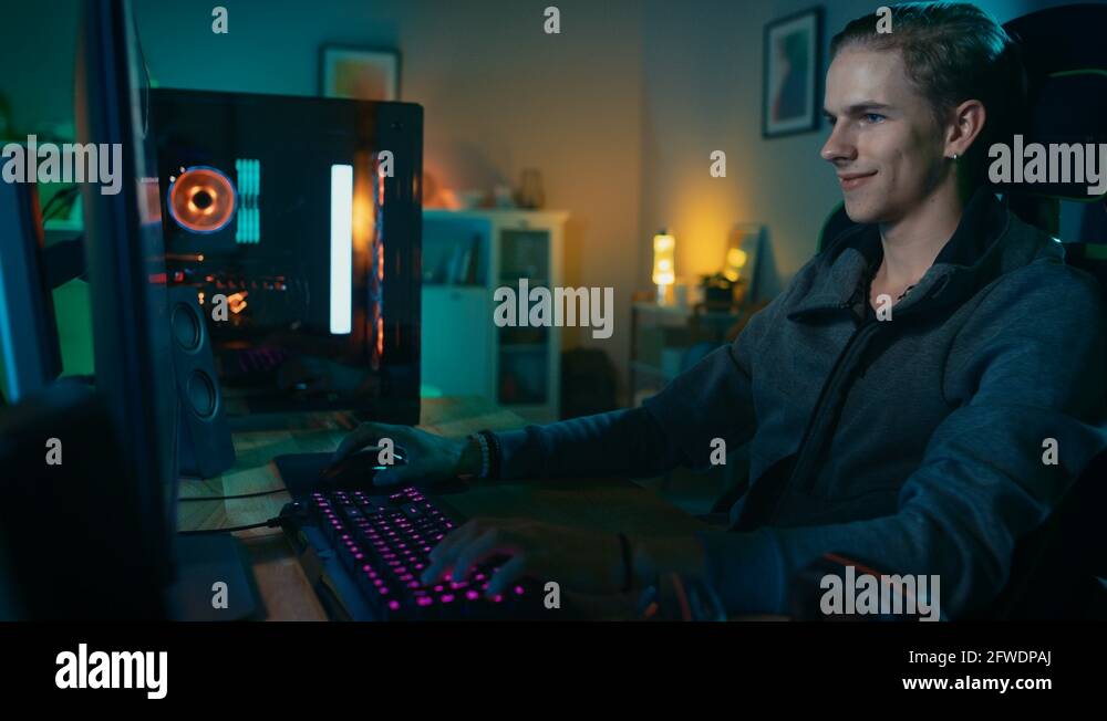 Happy Gamer Playing First-Person Shooter Online Video Game on His ...