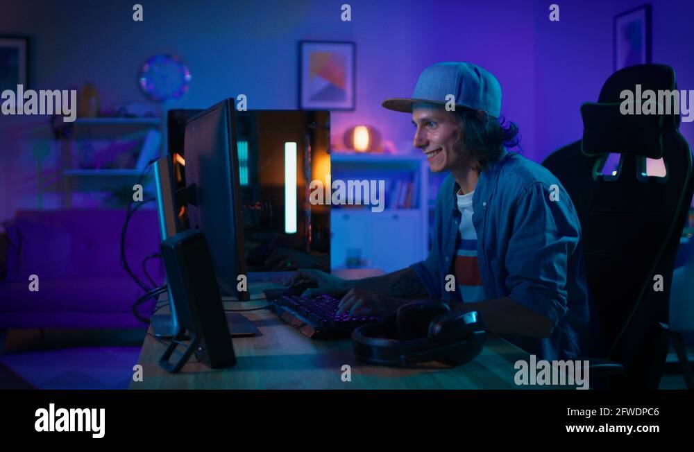 Excited Gamer Playing First-Person Shooter Online Video Game on His PC ...