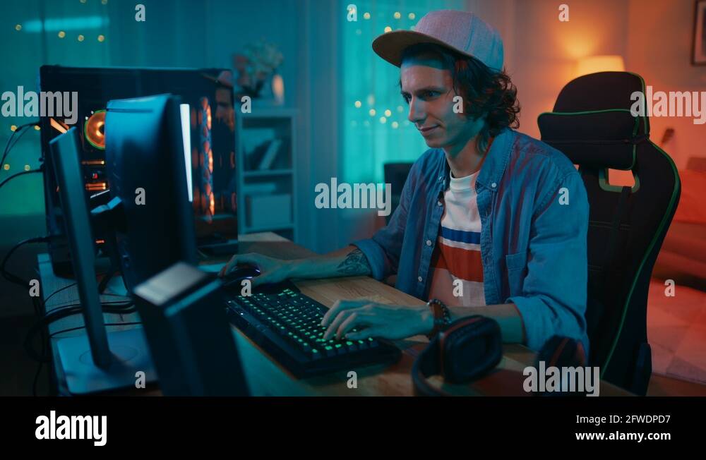 Excited Gamer Playing Online Video Game on His Personal Computer. Room ...