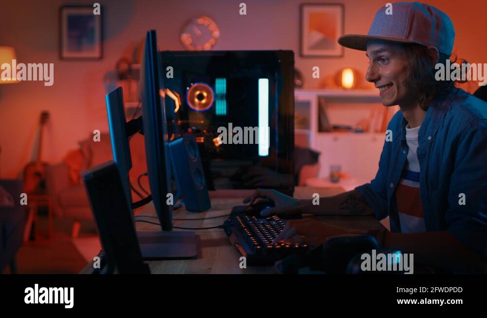 Excited Gamer Playing First-Person Shooter Online Video Game on His PC ...