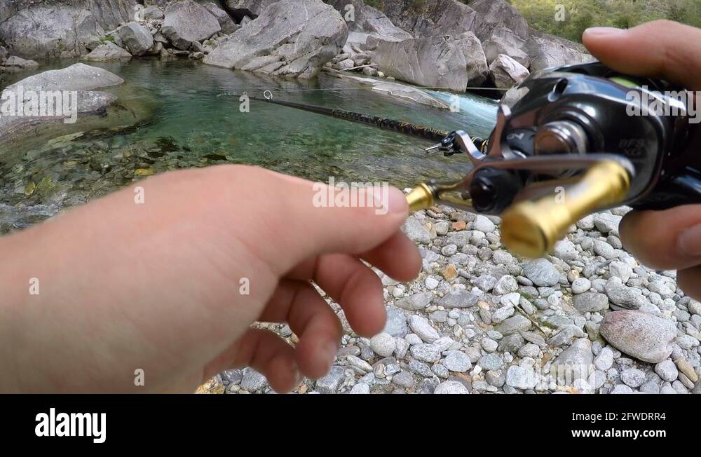 Fishing in a mountain stream, strike / bite of a fish, fight with a ...
