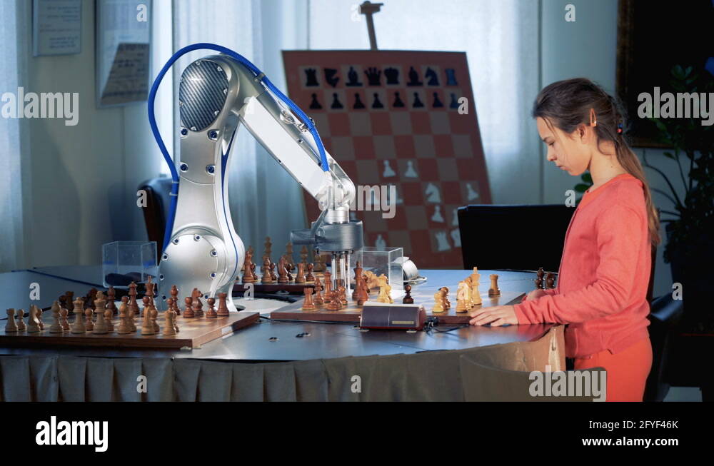 Smart scgool girl playing chess with a robotic arm, chess robot. Child ...