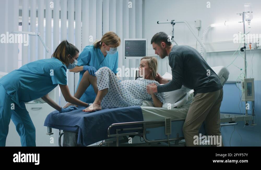 In the Hospital, Woman in Labor Gives Birth, Obstetricians and Doctors ...