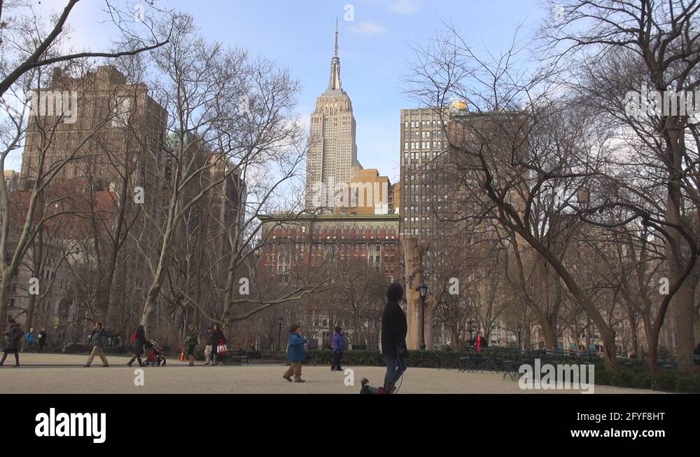 Kids playing New York City park by day iconic Empire State building ...