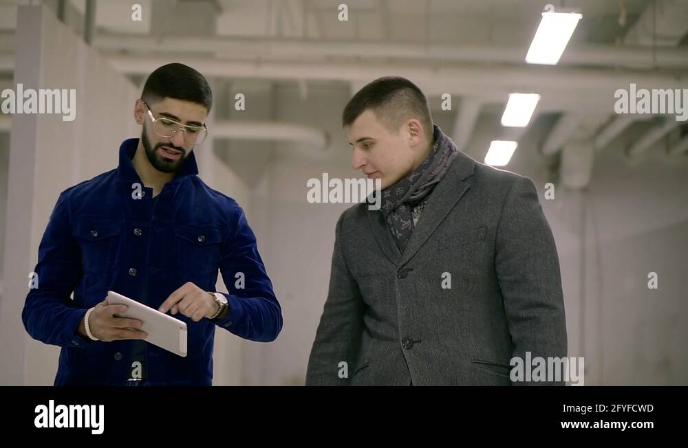 contractor is explaining to customer a plan of working, showing project ...