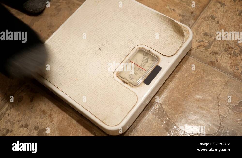 Man steps on broken scale on bathroom scale and weighs himself Stock ...
