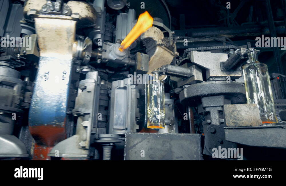 Rotary conveyor is transporting glass bottles from the releasing ...