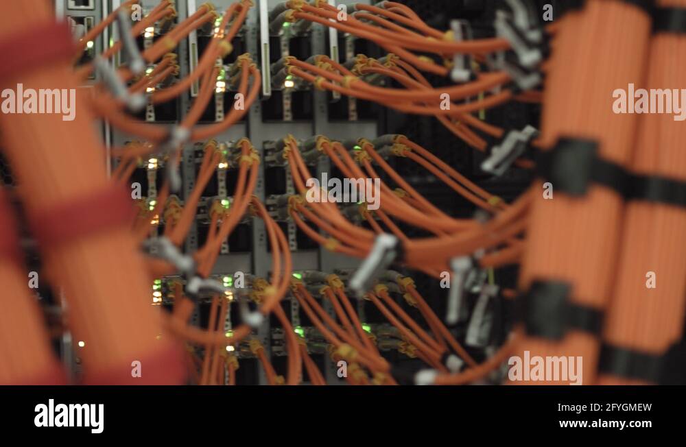 Rows of network cable connected to router and switch hub in server room ...
