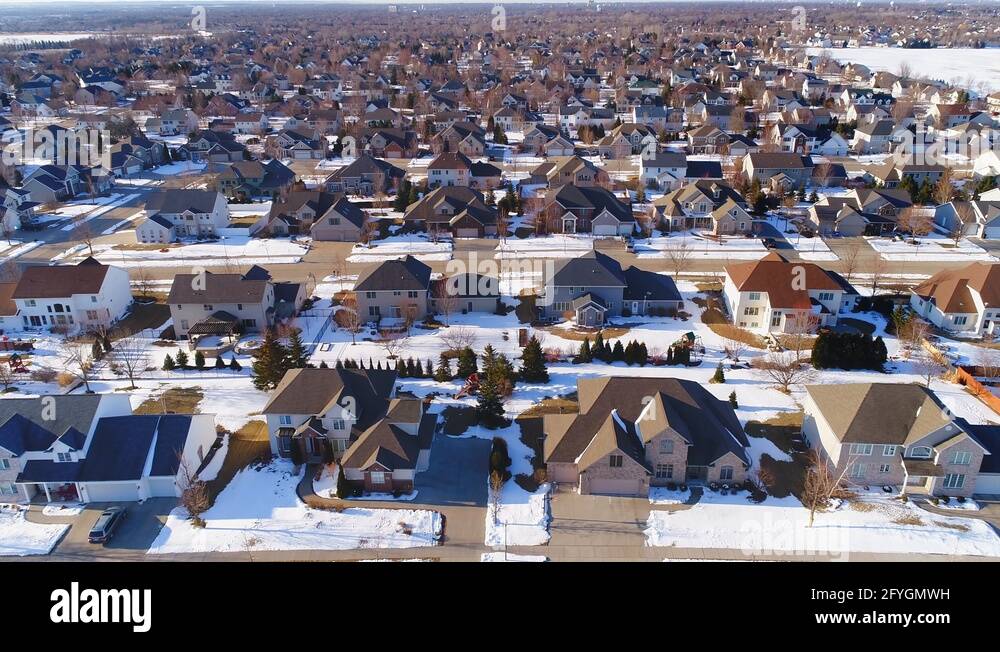 Beautiful neighborhoods, homes still frozen under snow in April, aerial ...
