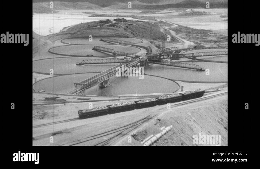 1950s: UNITED STATES: tailings inside thickening tanks. Tailing dams at ...