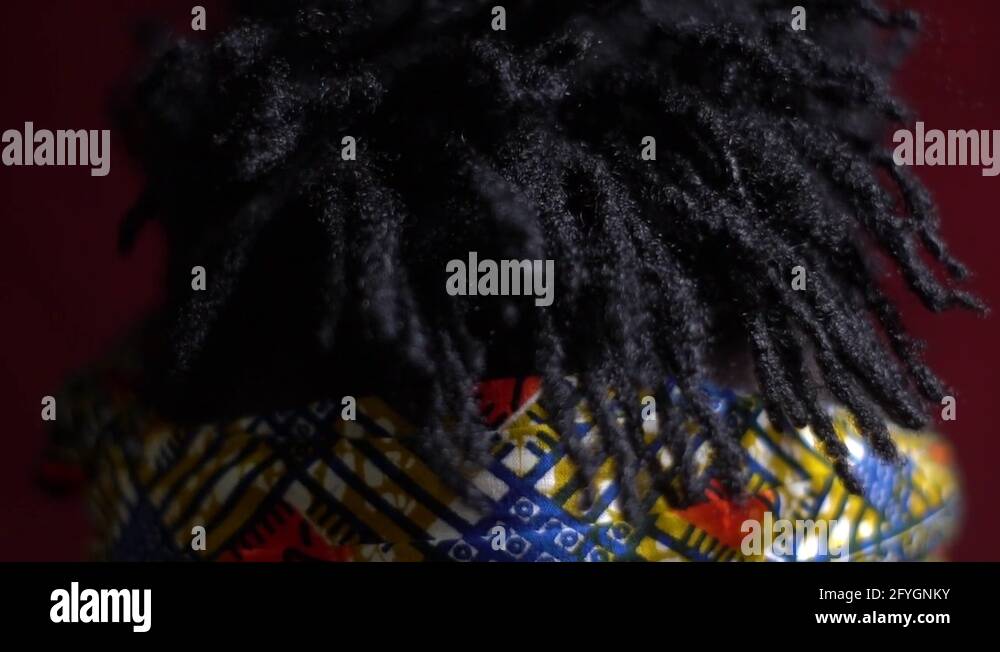 A black man with curly hair from Angola wears traditional clothes ...