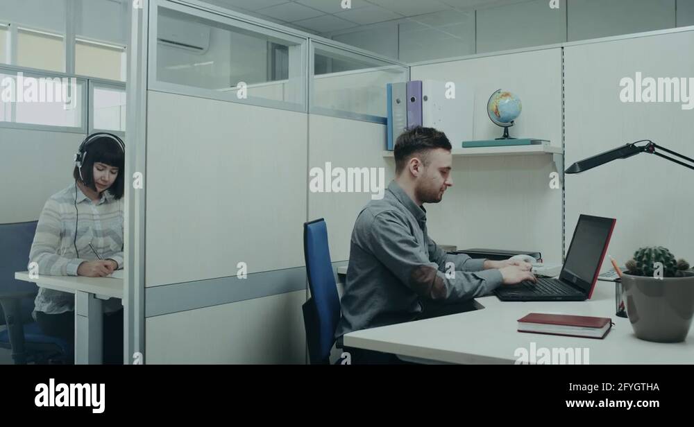 Typical working day in the office, young men and woman sitting on the ...