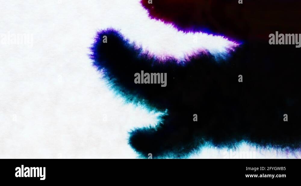 Dark colored ink spilling and bleeding on white paper background Stock ...