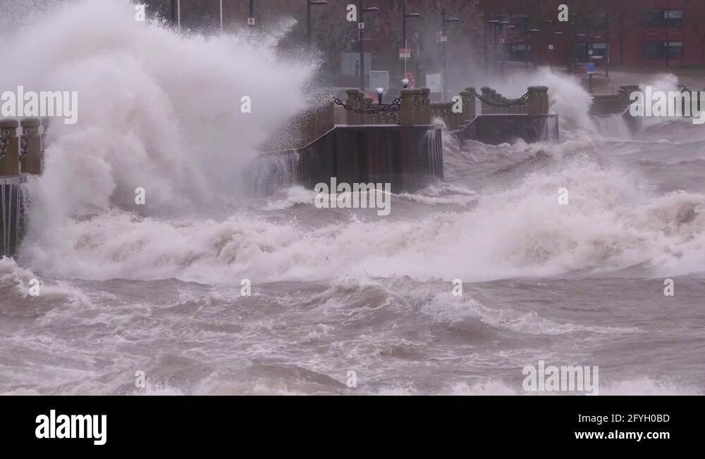 Wind driven waves crash into shore in typhoon and hurricane force wind ...