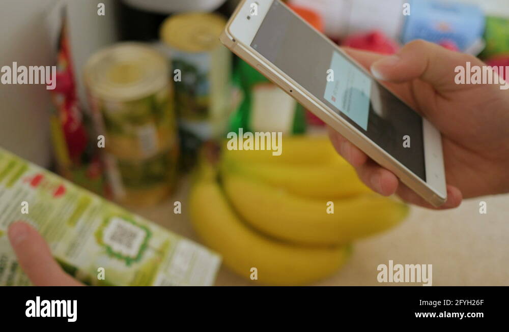 A man scans the QR code on a check on a juice box from a supermarket ...