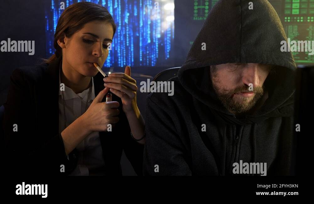 Police woman interrogating criminal hacker handcuffed in front of ...