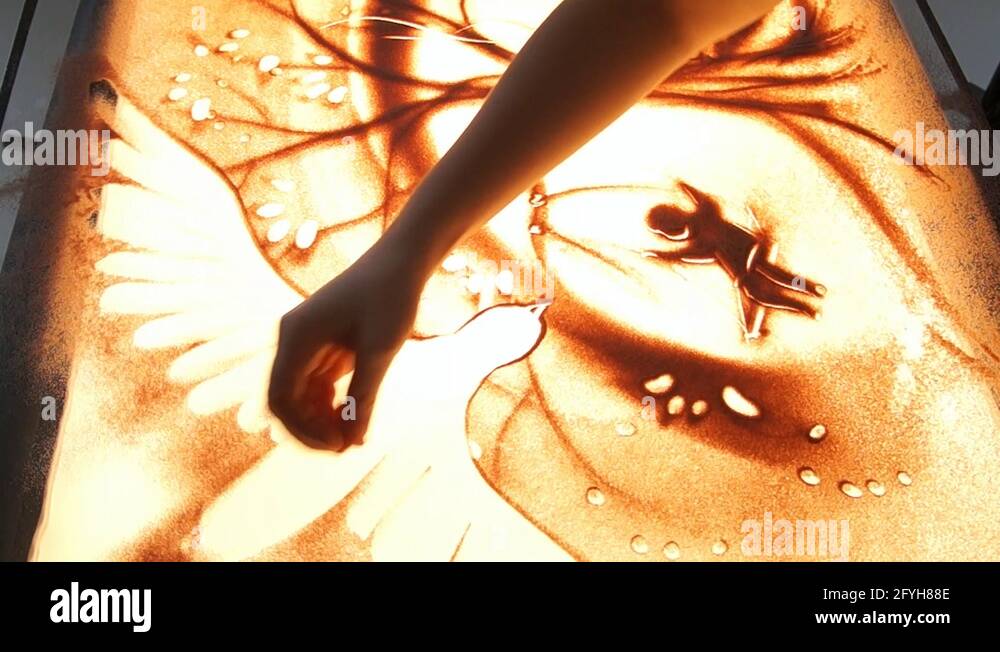 Drawing with sand. Drawing sand on a white screen. Sand Artist. Hands ...