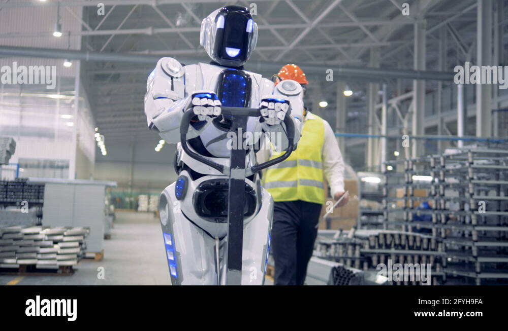 Cyborg is moving a transporting tool along the factory unit while being ...