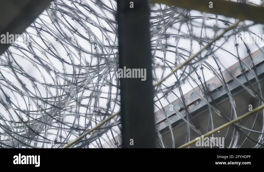 rack focus fence on prison fences, rainy day, prison life. neutral ...