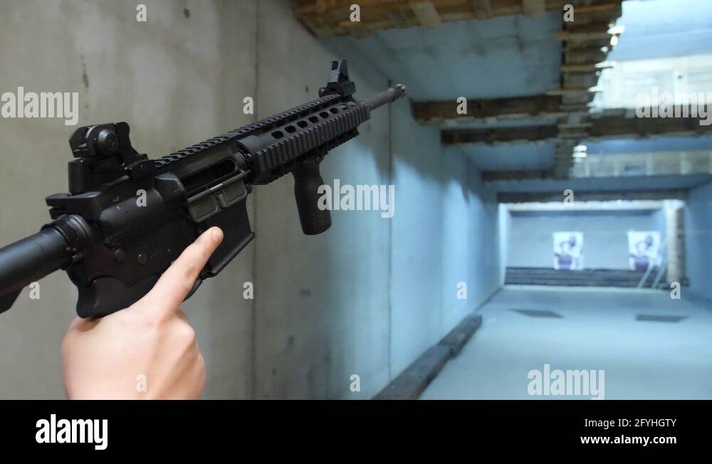 White male adult demonstrates how to load and reload an assault rifle ...