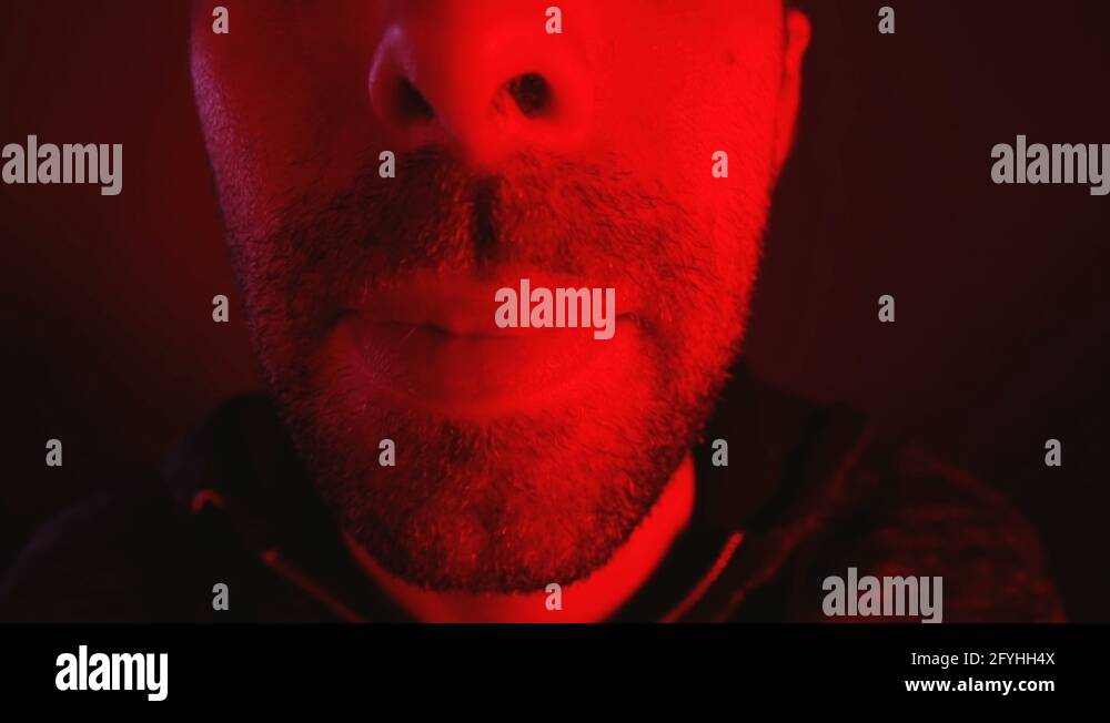 Man with seductive facial expression sticking out his tongue licking ...