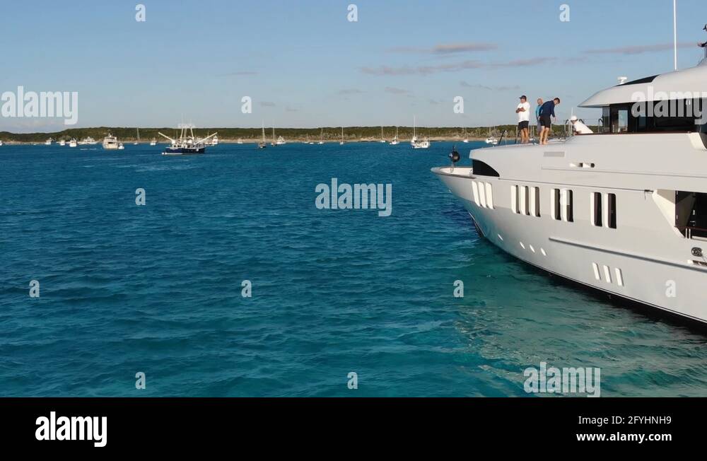 Man backflipping off yacht boat deck into ocean harbor. Large and small ...