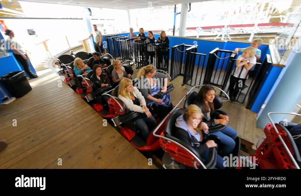 Amusement Park Excitement. A Fairground With Carnival Rides And Happy ...