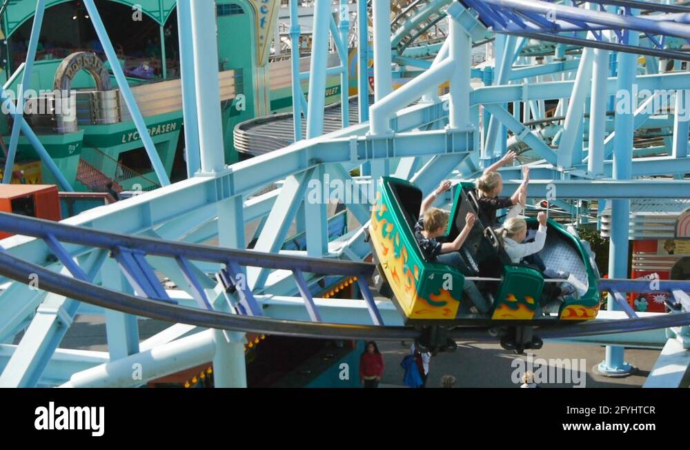 Amusement Park Excitement. A Fairground With Carnival Rides And Happy ...