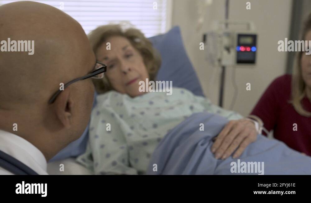 dolly around doctor talking to his elderly patient Stock Video Footage ...