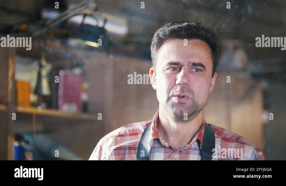 Blacksmith at work. Smoking cigarettes after work. Portrait Stock Video ...