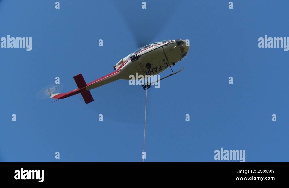 Helicopter, huey hover overhead with cable Stock Video Footage - Alamy