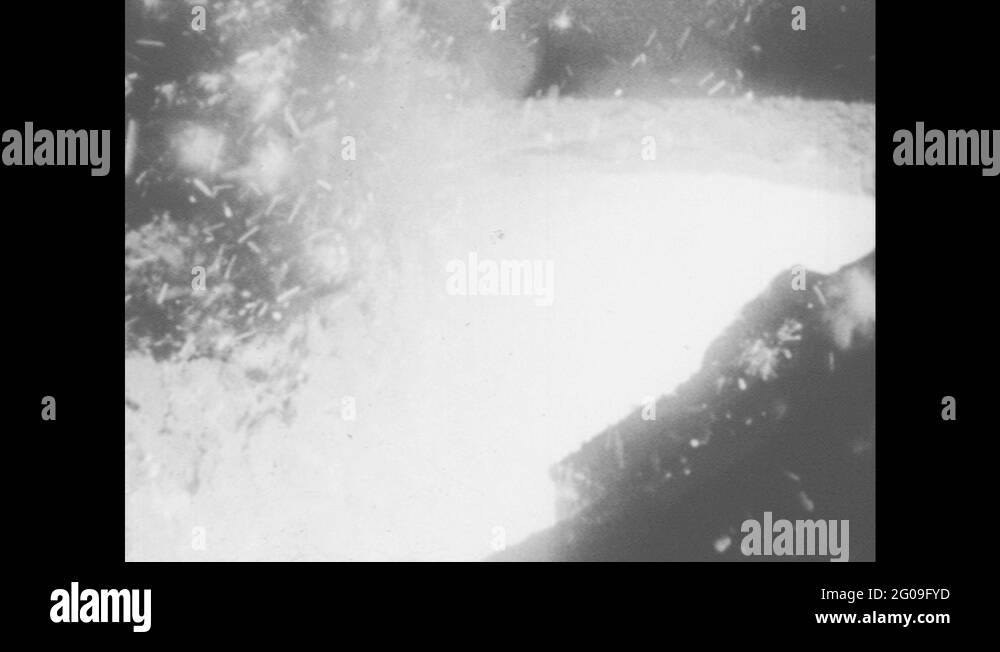 1960s: Smoldering hot material in tunnel. Train carries industrial ...