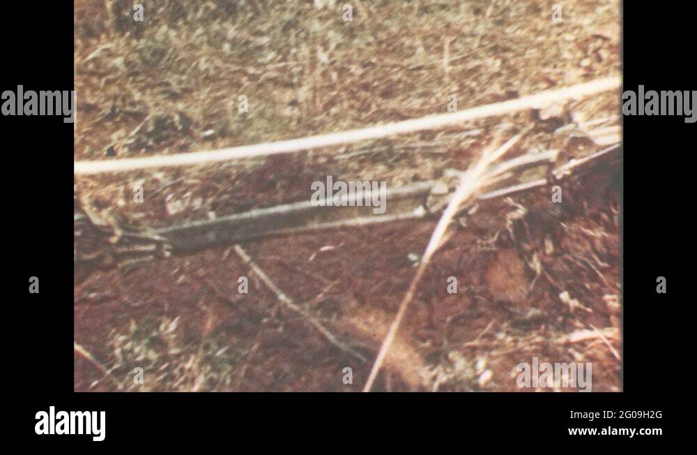 1950s: plow tills soil. men toss brush onto bonfires that smoke in farm ...