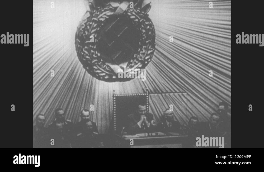 1950s: Views of Nazi rally, Adolph Hitler speaking. Hands salute Hitler ...