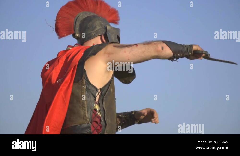 The wounded gladiator in the armor fights on swords and loses the ...