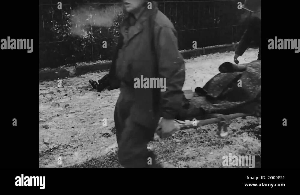 WW2 - US soldiers carry injured soldier on litter Stock Video Footage ...
