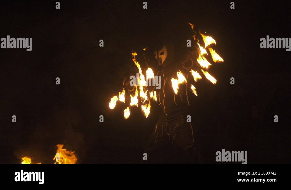 Fiery dance. Amazing magical Fire Show at night. Slow shutter speed ...