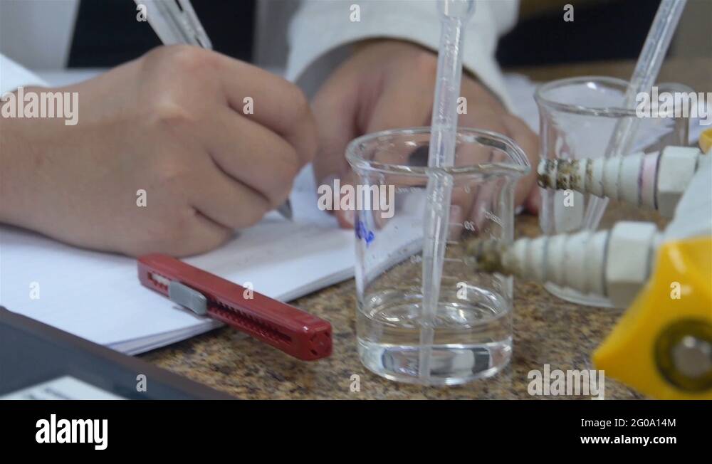 Girl Taking Notes In A Chemistry Lab - Close Up - Movement - Right To ...