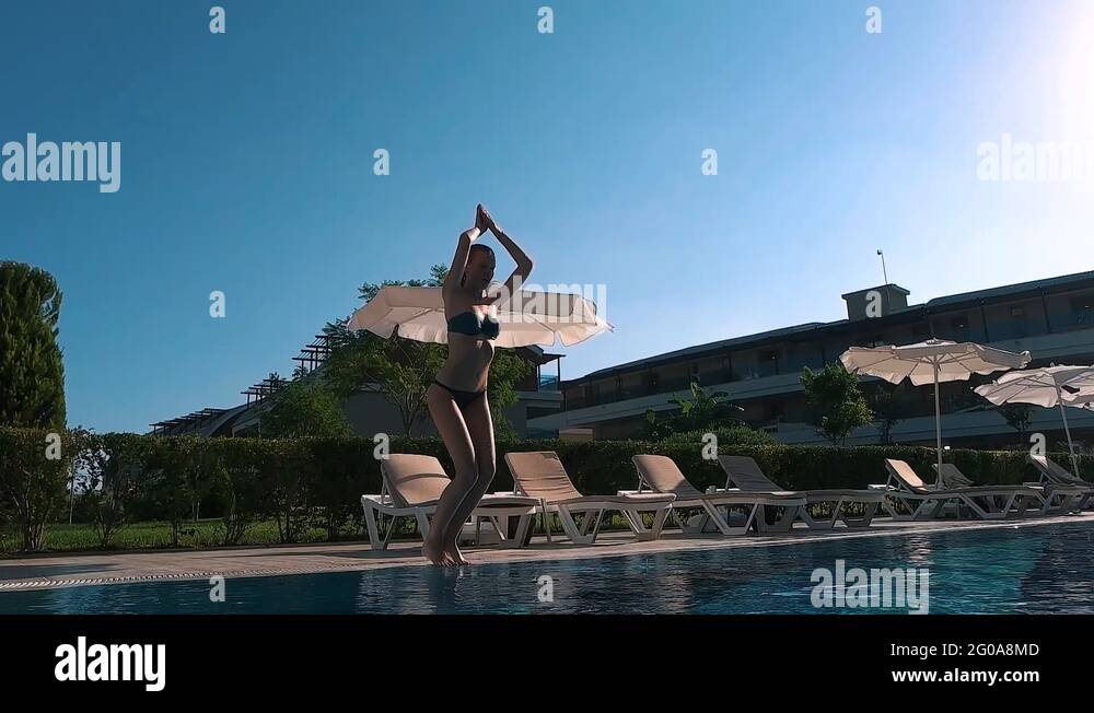 girl jumping into the pool Stock Video Footage - Alamy