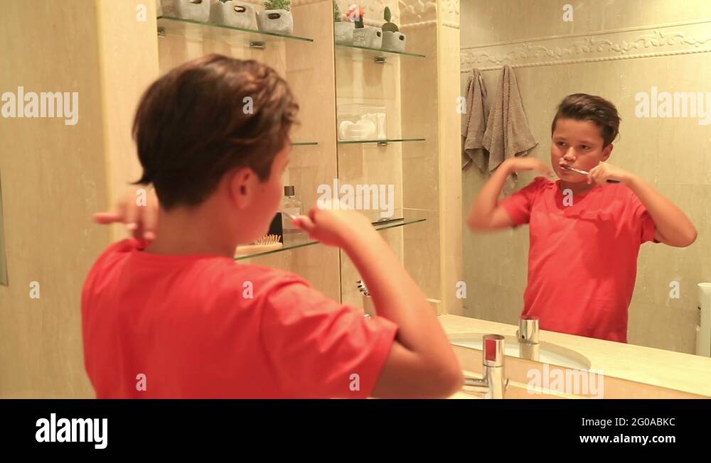 Teenage boy brushing teeth 3 Stock Video Footage - Alamy
