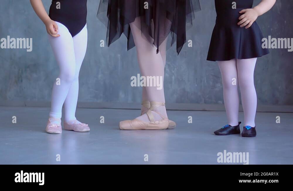 Little girls try to repeat the movements on ballet occupation. Little ...