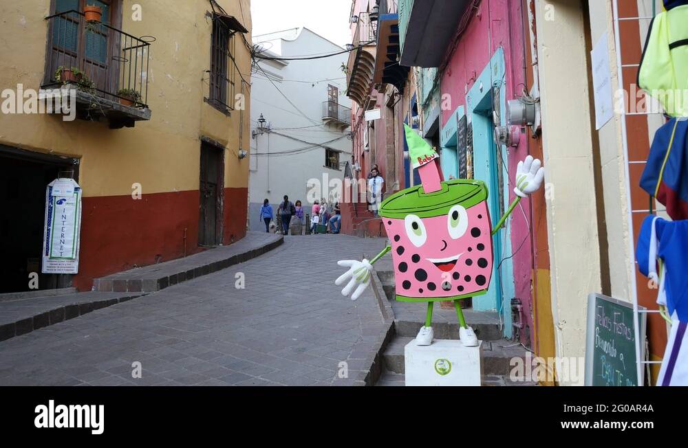 Mexico Guanajuato people walking on street with pink sign Stock Video ...