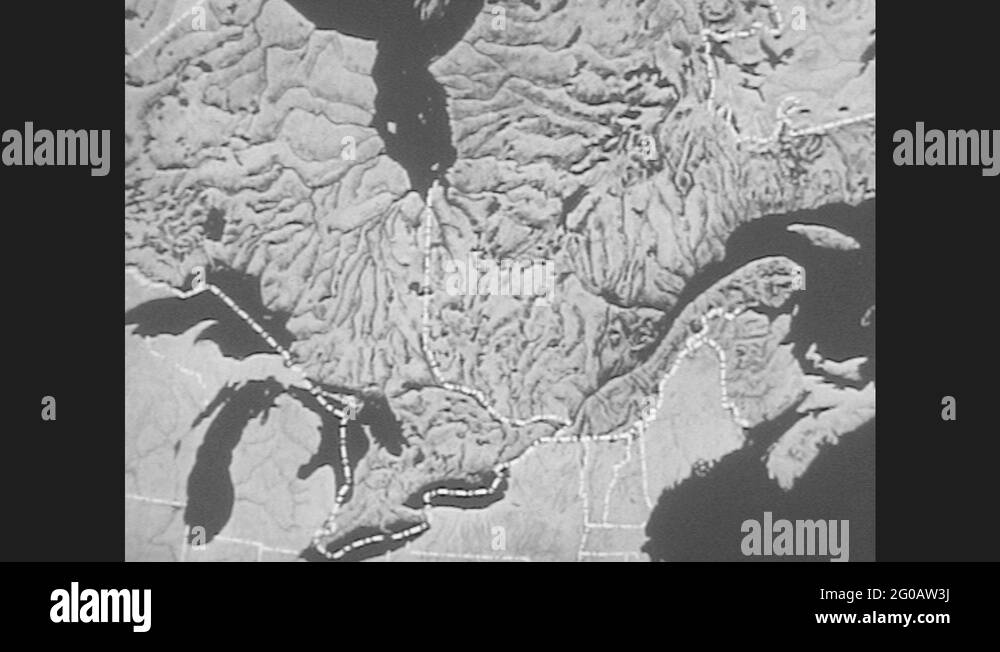 1950s: Map of Canada with text. Bucket dredge digs into earth. Train ...