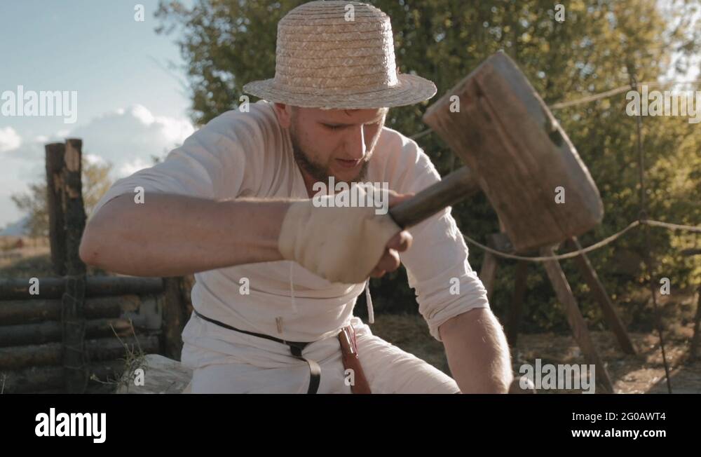 Medieval carpenter with the hammer and chisel carves from wood Stock ...