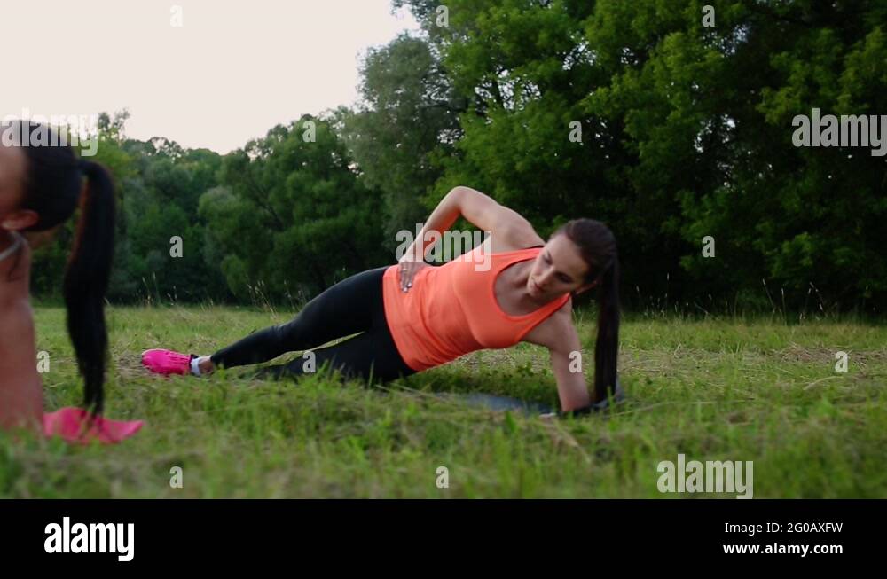 Fit woman doing plank exercise, working on abdominal midsection muscles ...