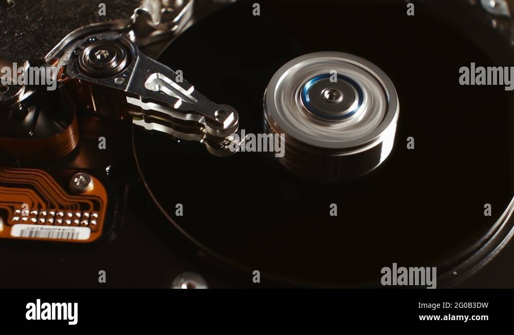 HDD failure. The internal structure of the hard disk on dark background ...
