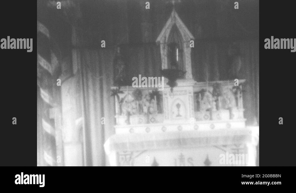 Hawaii 1930s: priest in black gown stands by church altar, sign for New ...