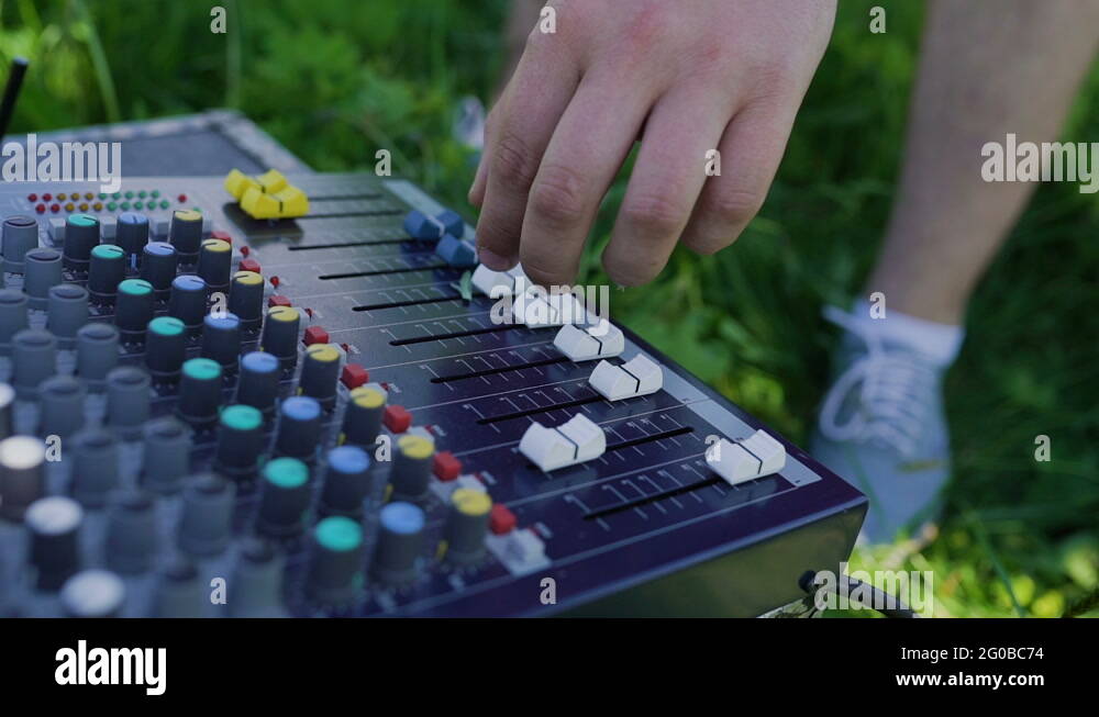 The sound operator adjusts the mixing console Stock Video Footage - Alamy