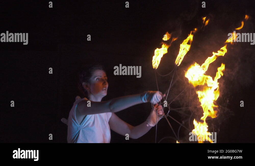 Fiery dance. Amazing magical Fire Show at night. Slow shutter speed ...